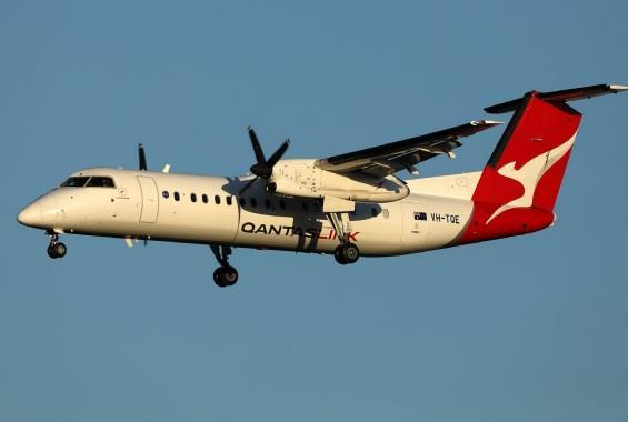 Departing QantasLink Dash 8 lined up with edge lights on take-off ...
